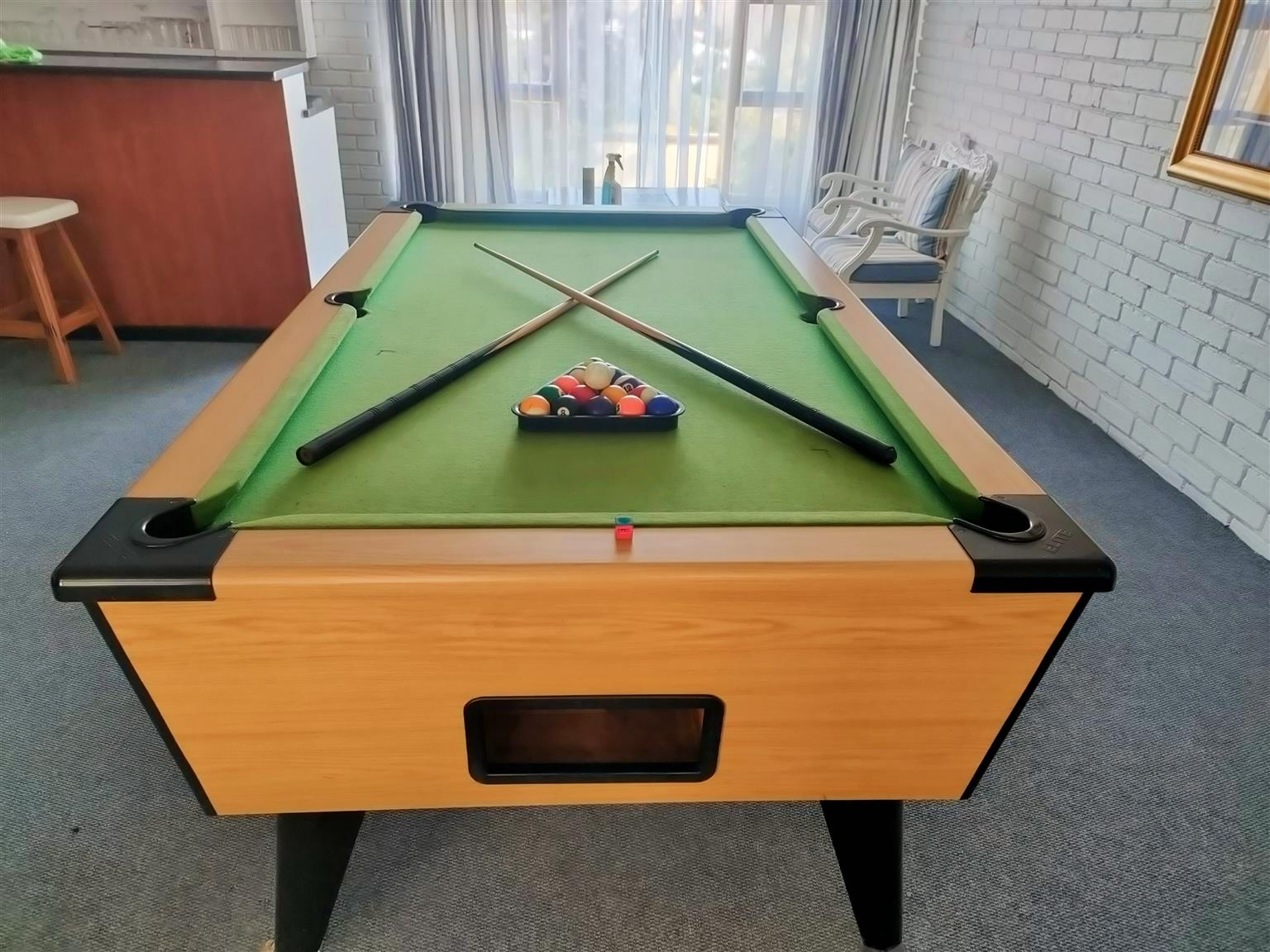Solid oak pool table with green felt top.Two cues and cue stick holder ...