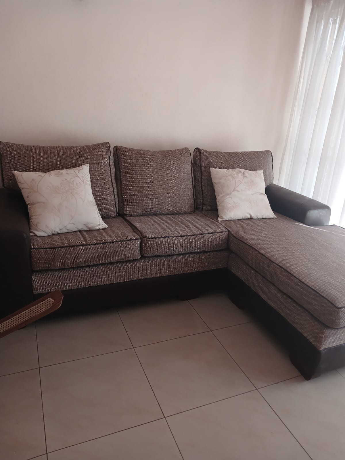 L shaped fabric couch with leather like finishes and 32 inch samsung TV ...